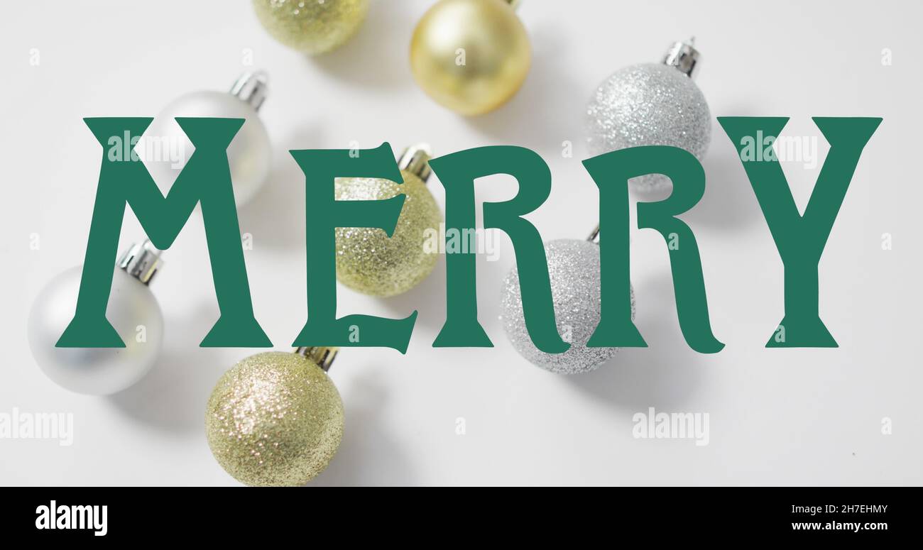 Image of merry text over christmas baubles Stock Photo - Alamy