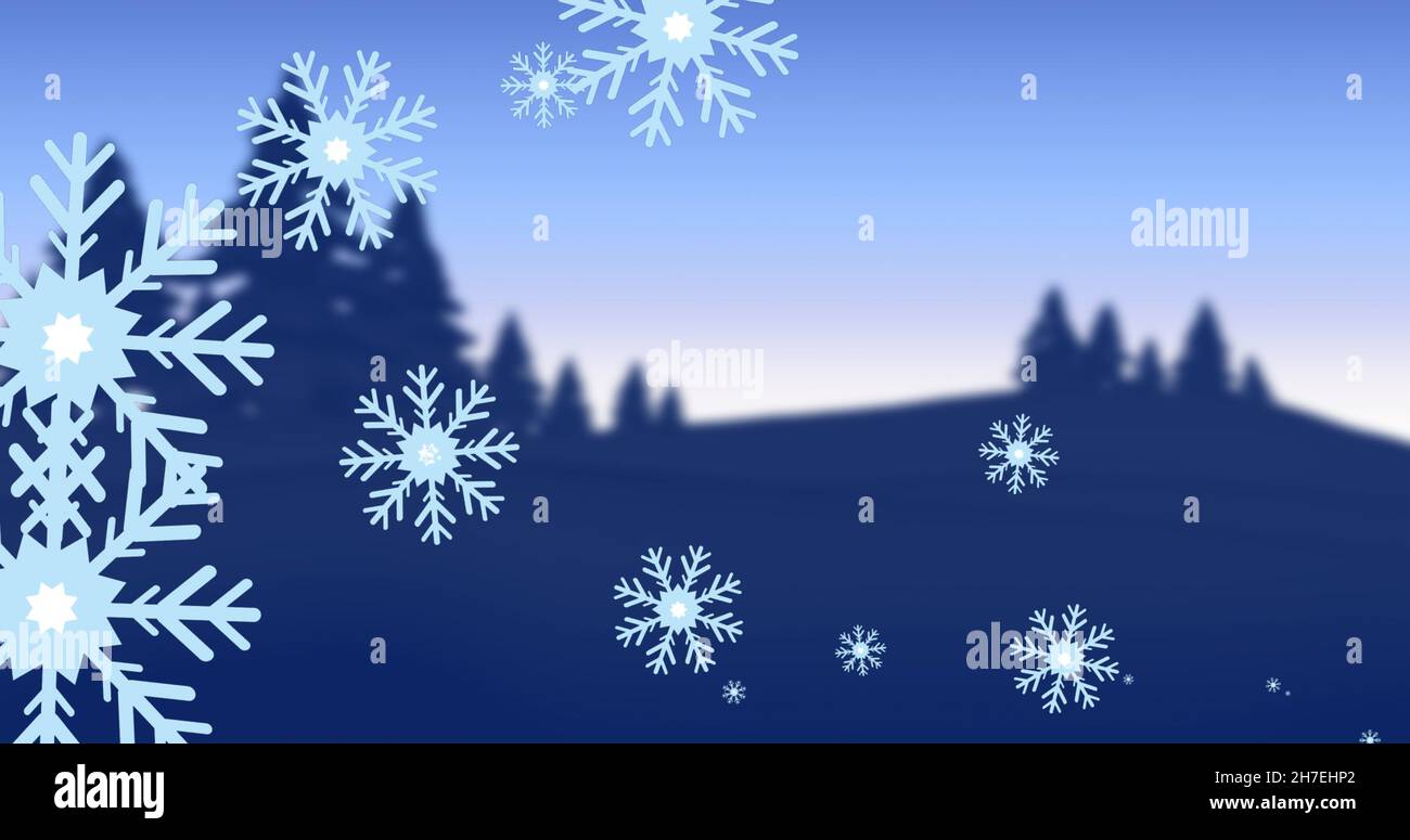 Image of falling snowflakes over silhouetted trees and landscape at ...