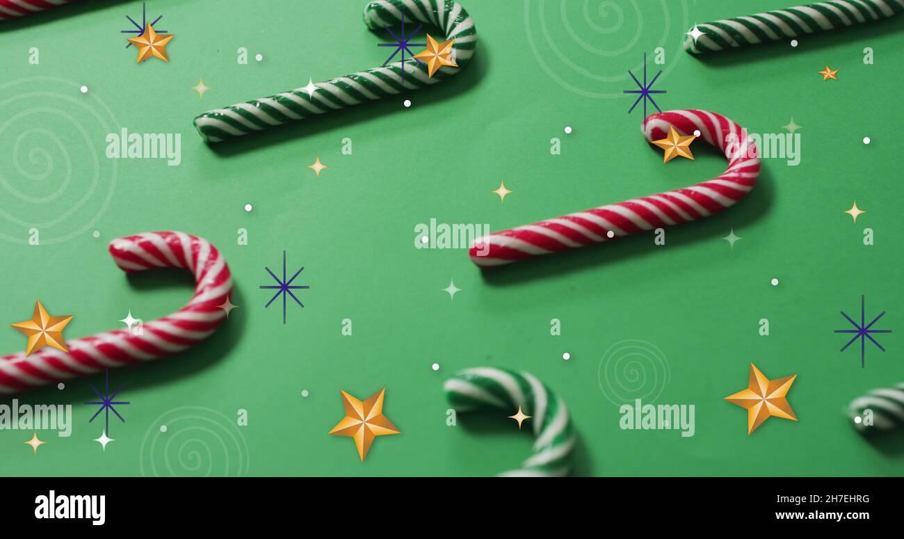 Image of stars over christmas candy canes Stock Photo - Alamy