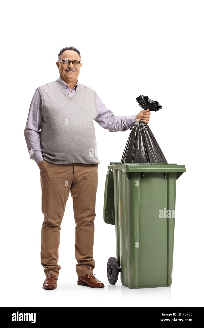 Full length portrait of a mature man throwing a black plastic bag in a ...
