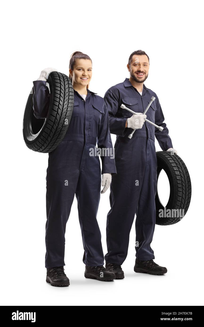 Male and female auto mechanic workers holding lug wrench tool and a car ...