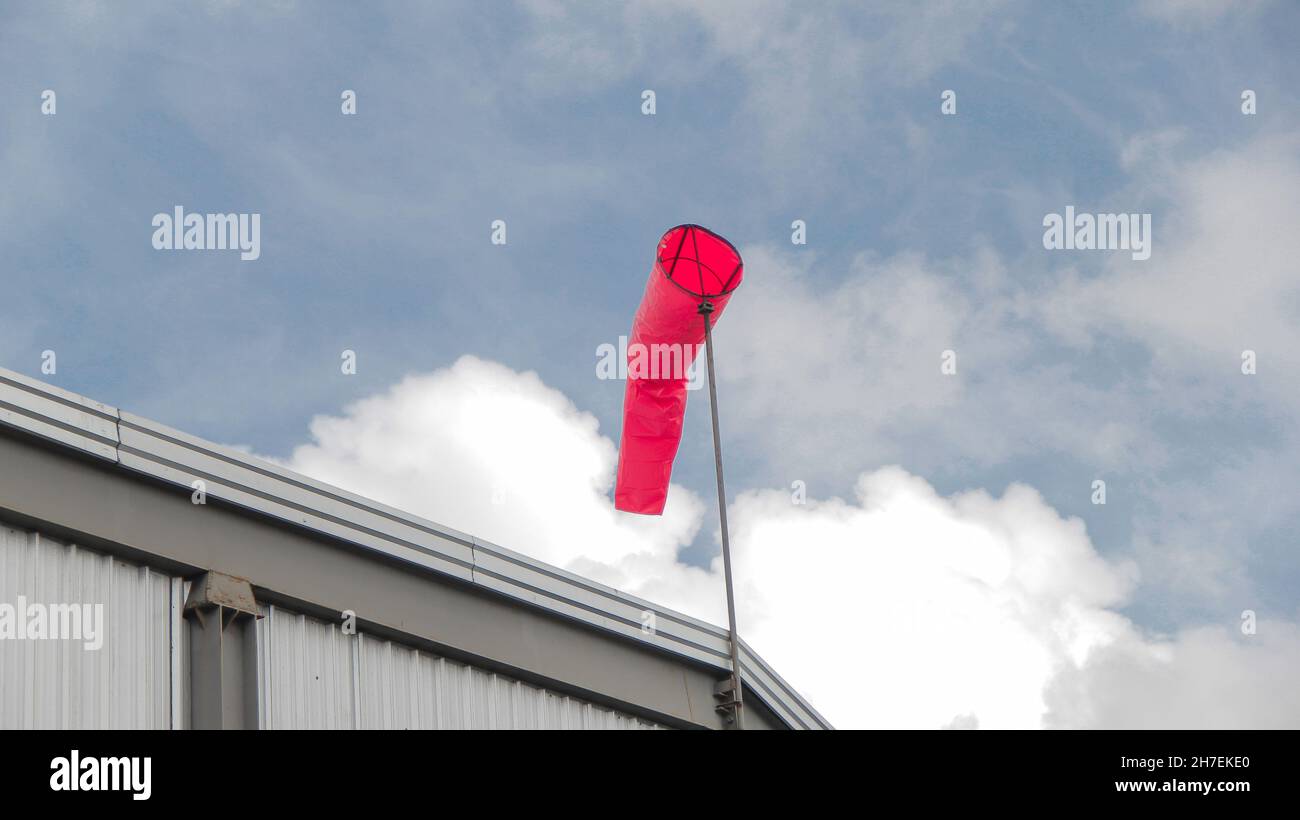 Low angle shot of a red windsock on the building Stock Photo - Alamy