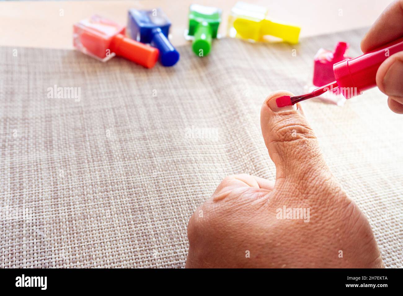 Male hand with colorfully painted fingernails Stock Photo - Alamy