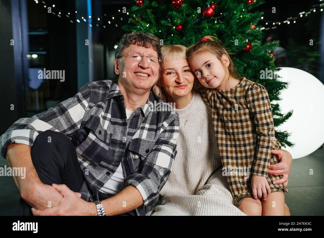 Cute family posing for a christmas photo, elders with their precious ...