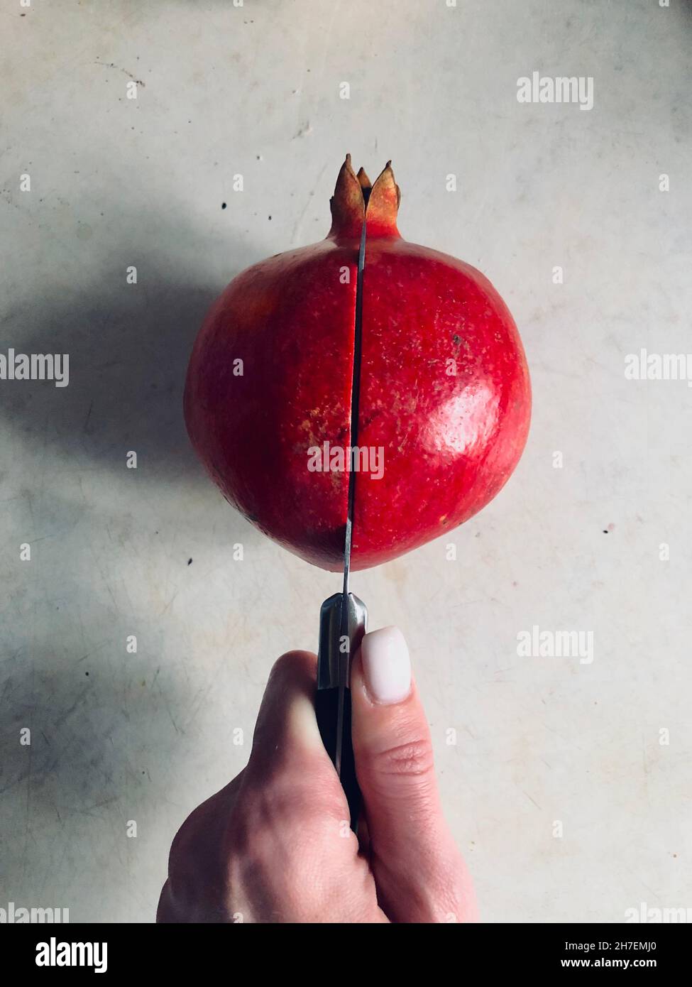 Hand holding pomegranate hi-res stock photography and images - Alamy