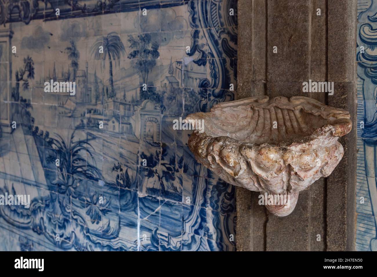 Baptismal font inside a Portuguese church whose walls are covered with ...