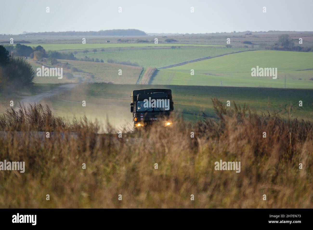 forward cab view of a British army MAN SV 4x4 driving a dusty stone ...