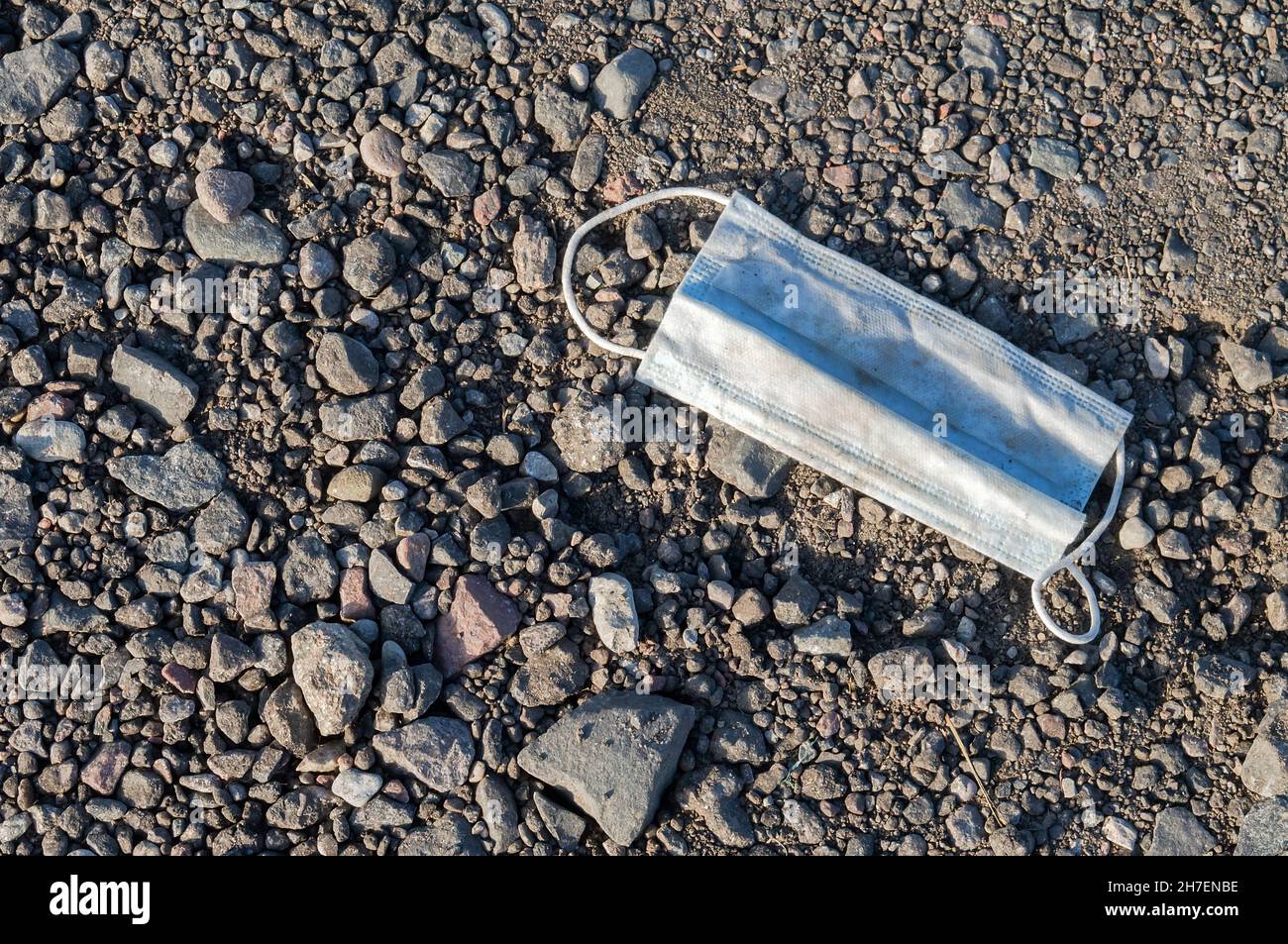 Medical mask lying on the ground. Trash on the road. Pollution of ...