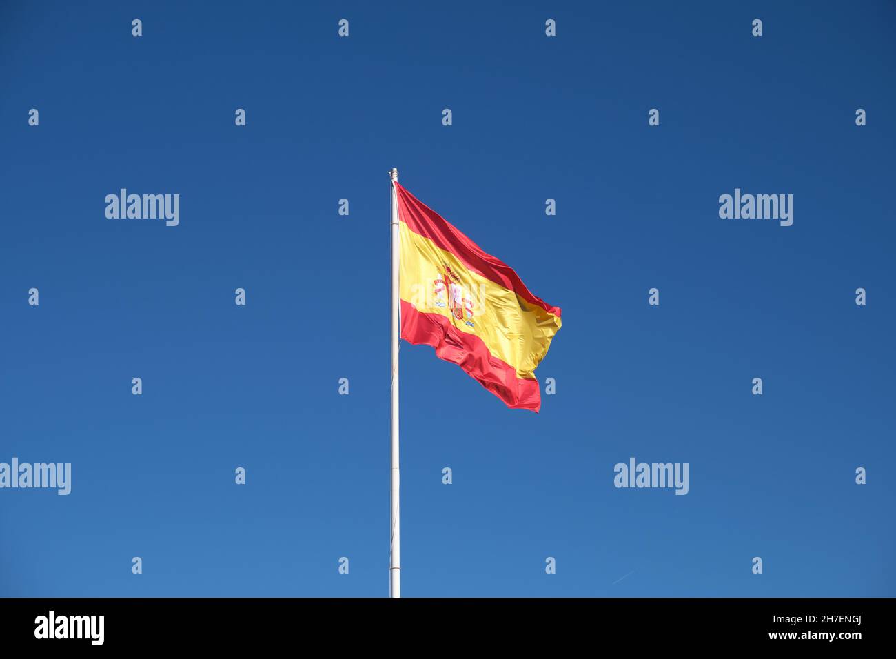 Spanish flag flying on blue sky Stock Photo - Alamy