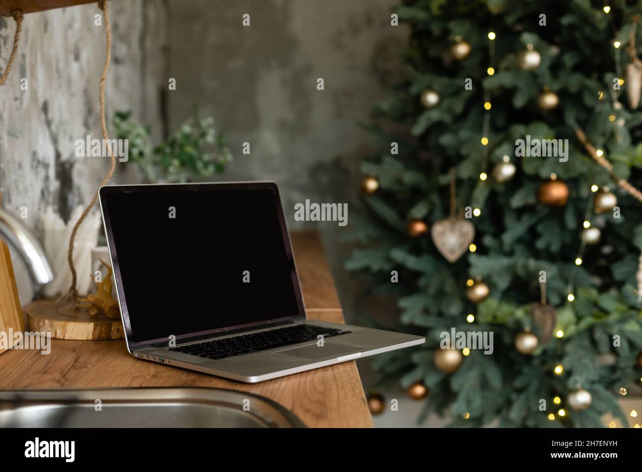 Laptop. Christmas tree and gifts on background Stock Photo - Alamy