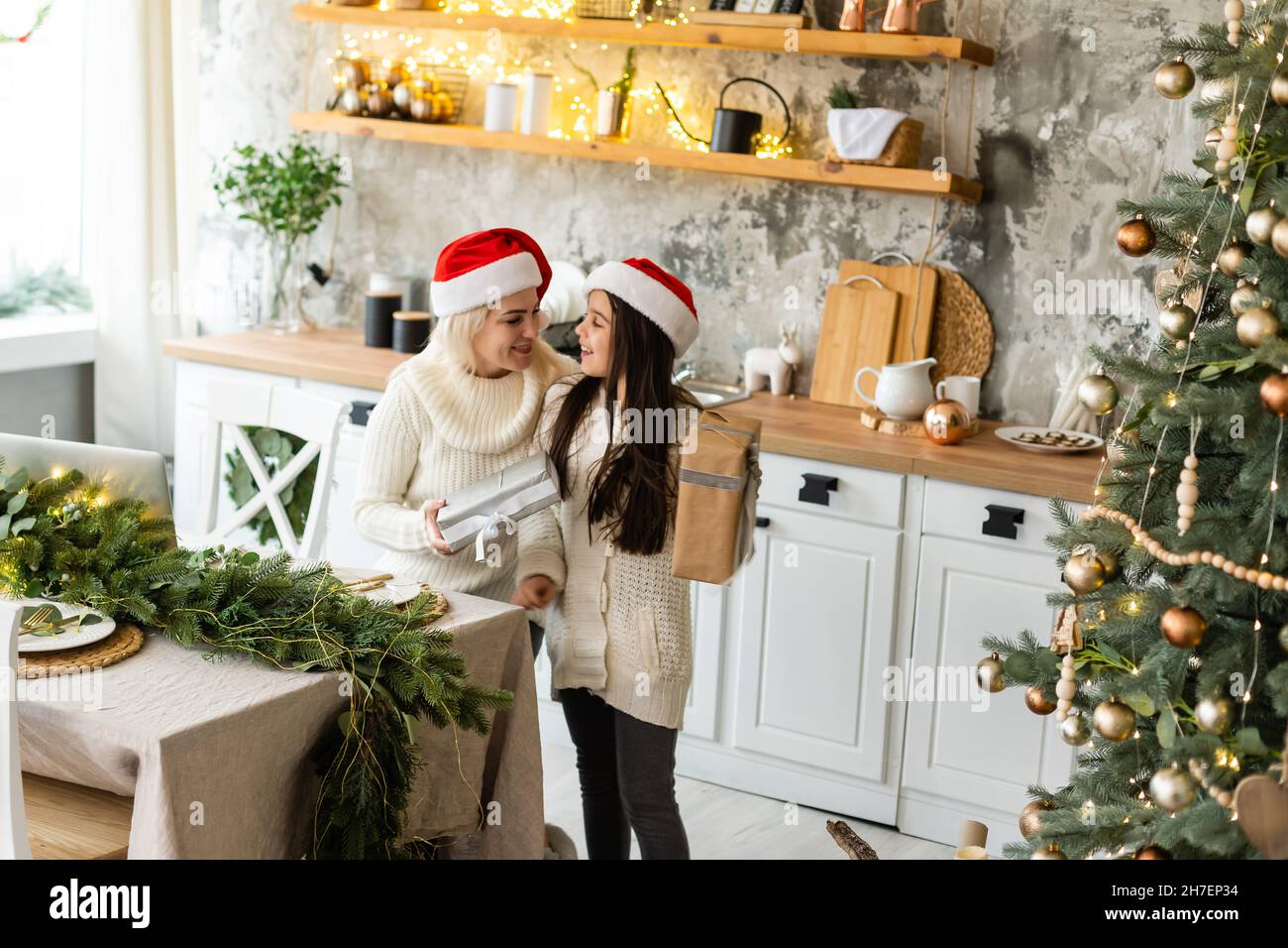 Beautiful young family enjoying their holiday time together, decorating ...