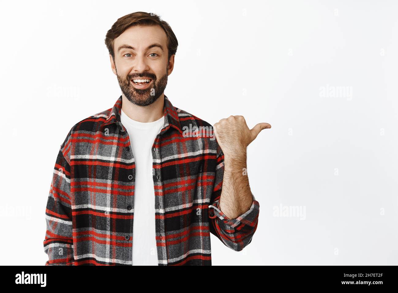 That way. Smiling happy bearded man demonstrating advertisement ...