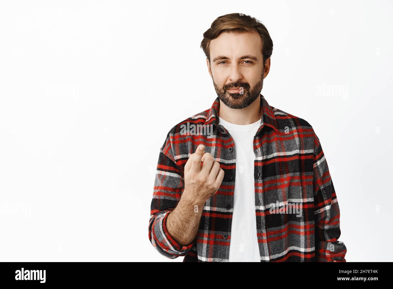 Image of handsome bearded man pointing finger at camera, squinting ...