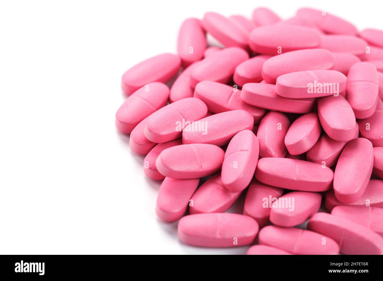 Pink vitamin pills for women on a white background. Multivitamins for ...