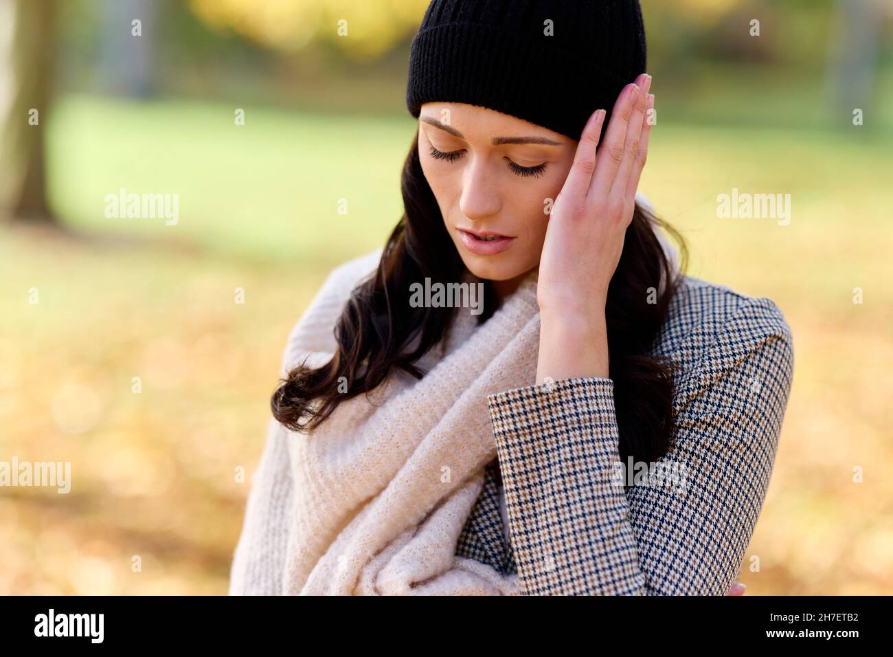 Woman looking concerned outdoors Stock Photo - Alamy