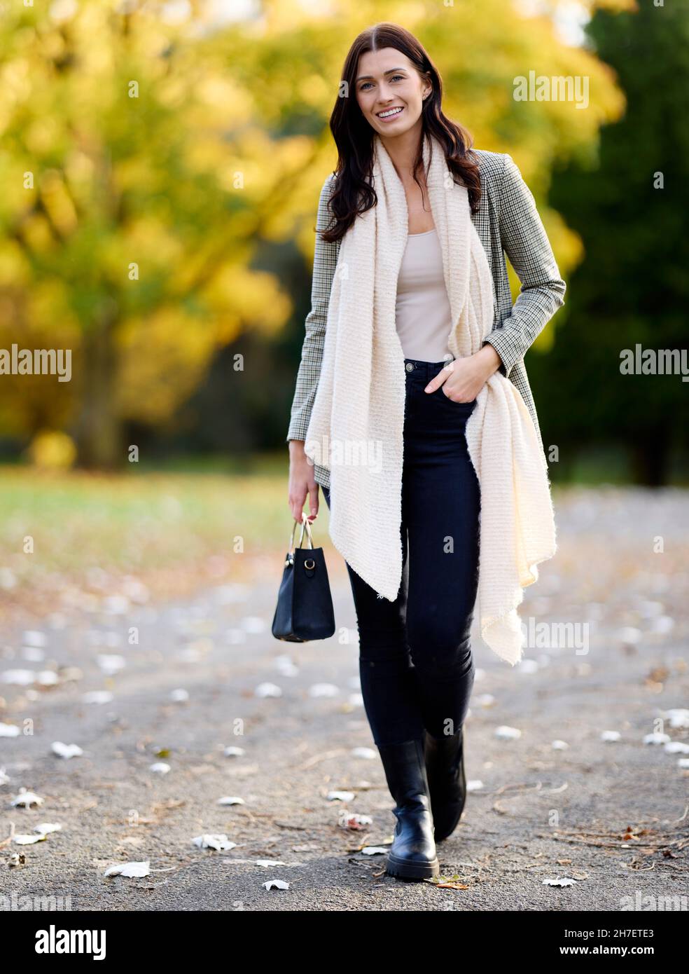 Attractive woman walking outdoors Stock Photo - Alamy