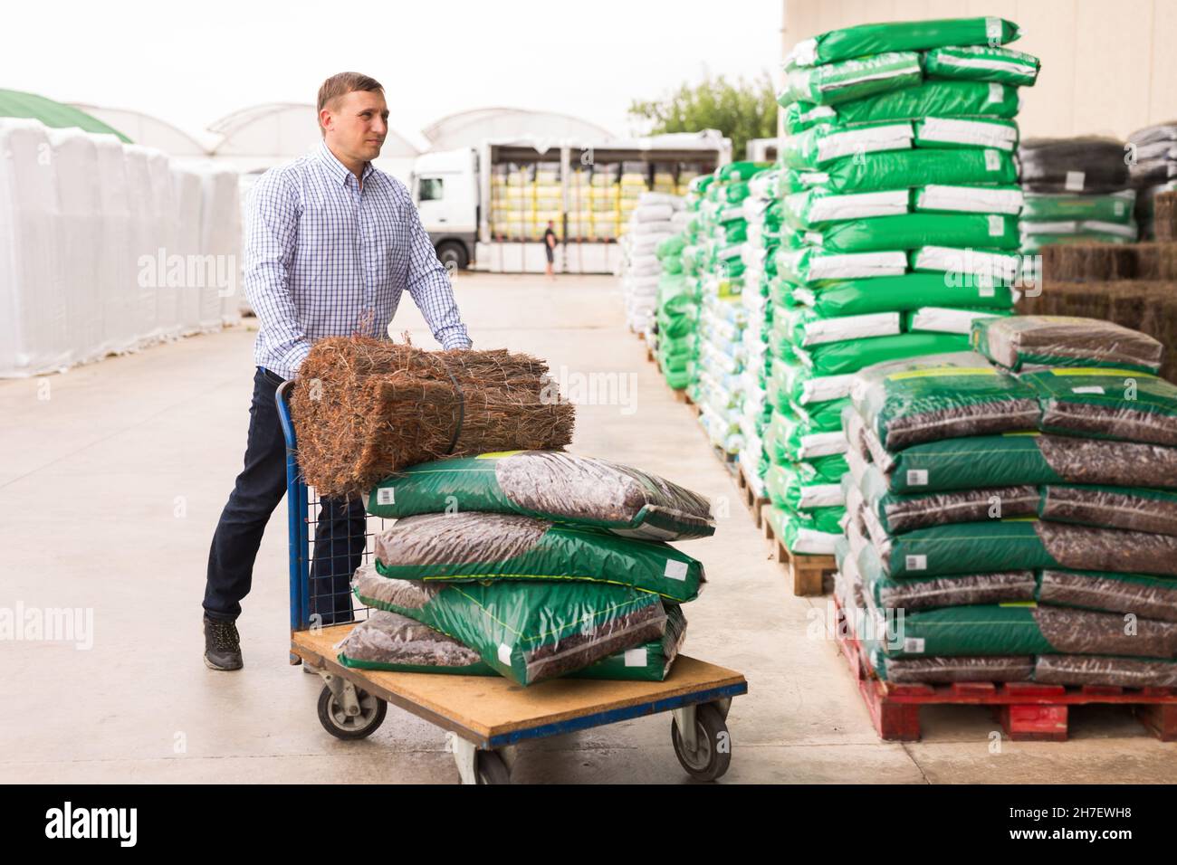 Customer buying fertilizer in store Stock Photo - Alamy