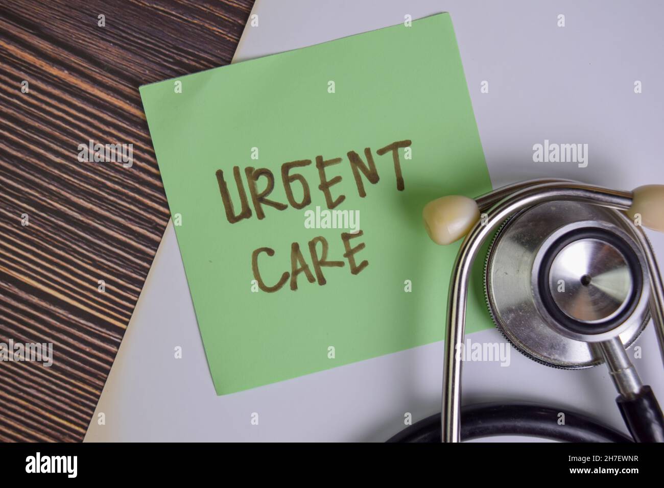 Urgent Care write on sticky notes isolated on Wooden Table Stock Photo ...