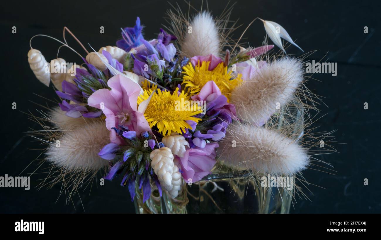 Colorful Easter composition made of dried flowers isolated on a black ...