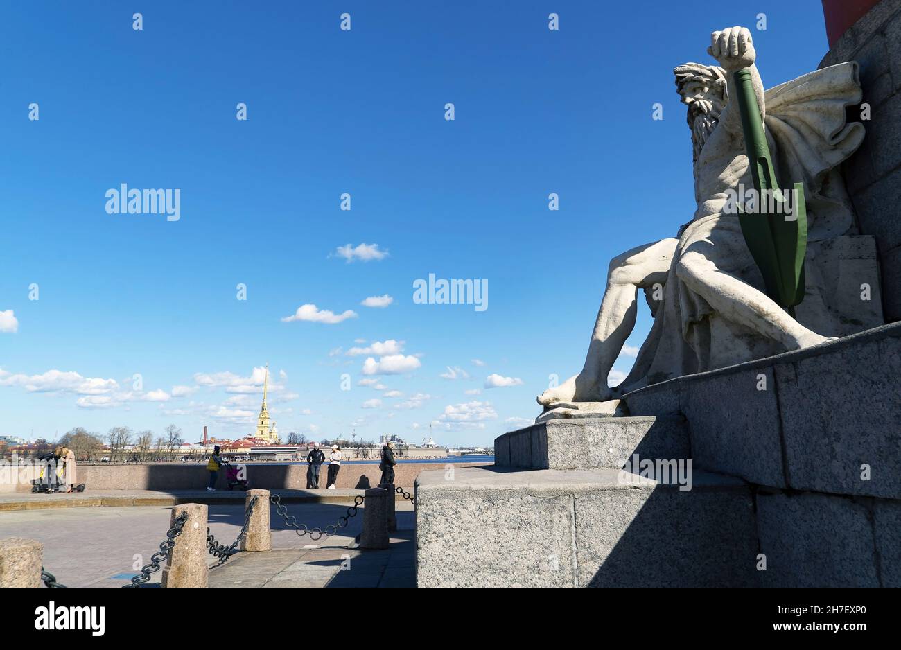 The statue at the foot of the Rostral Column. The arrow of Vasilievsky ...