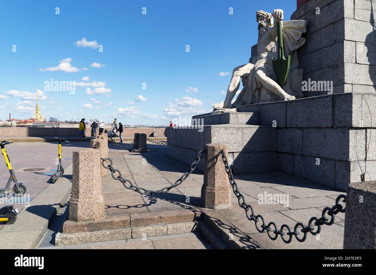 The statue at the foot of the Rostral Column. The arrow of Vasilievsky ...