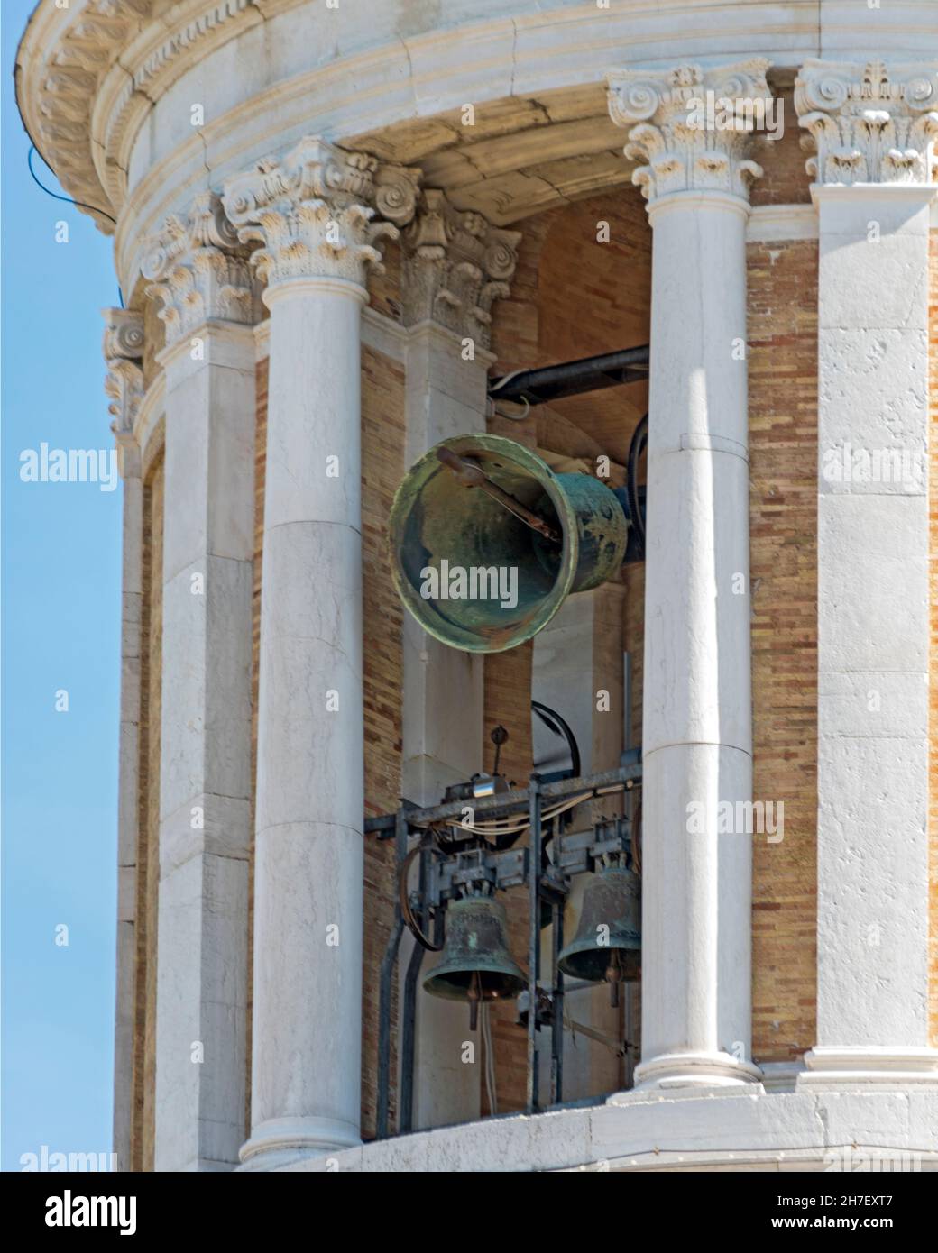 A bronze bell is ringing between two white marble columns at the top of ...