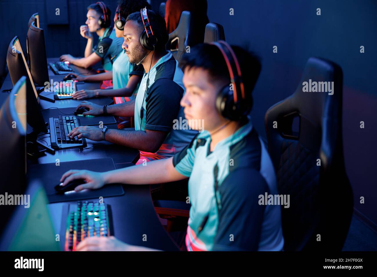 Busy men focused on video game development in club Stock Photo - Alamy