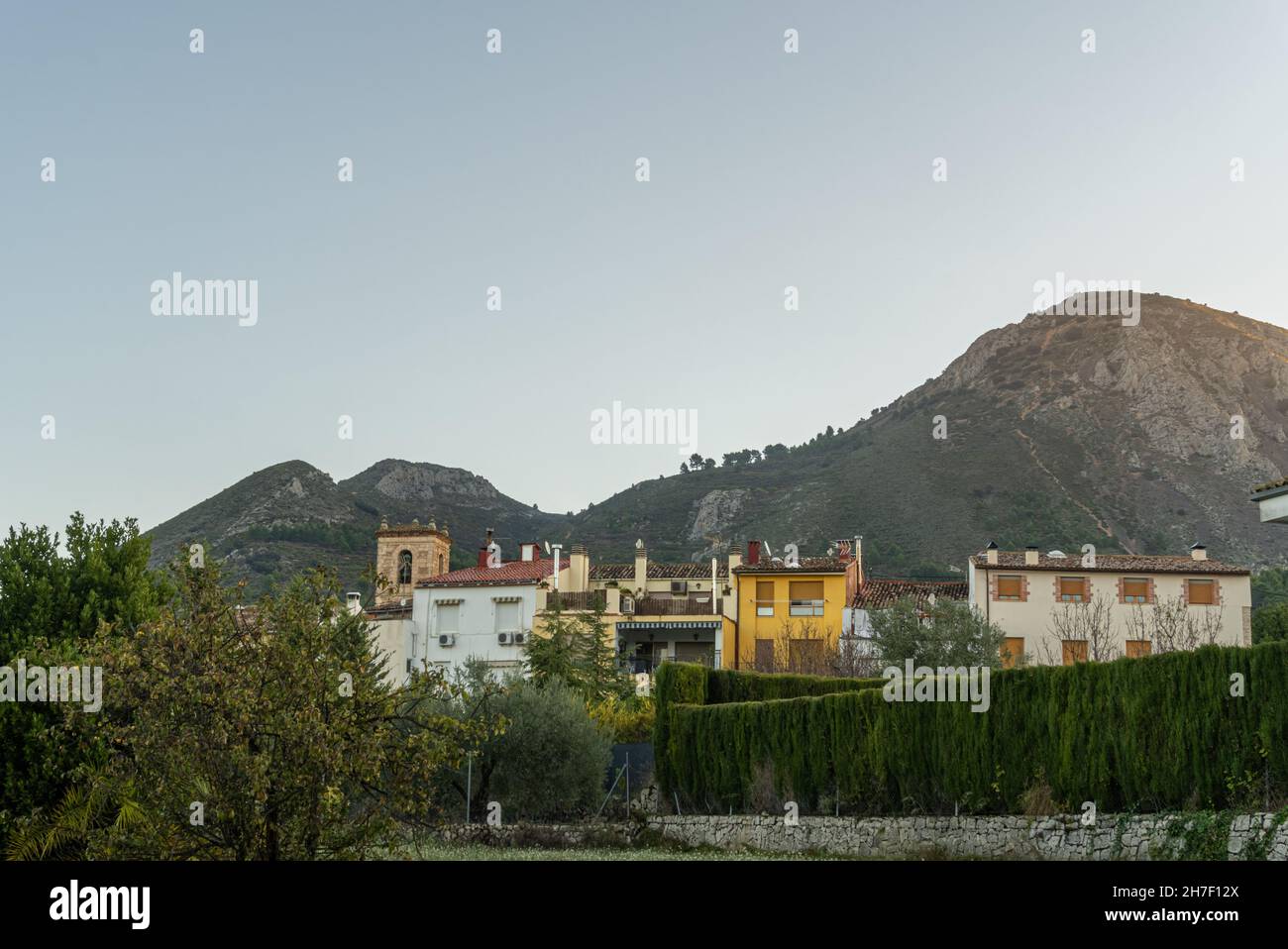 Residential buildings surrounded by mountains in the countryside Stock ...