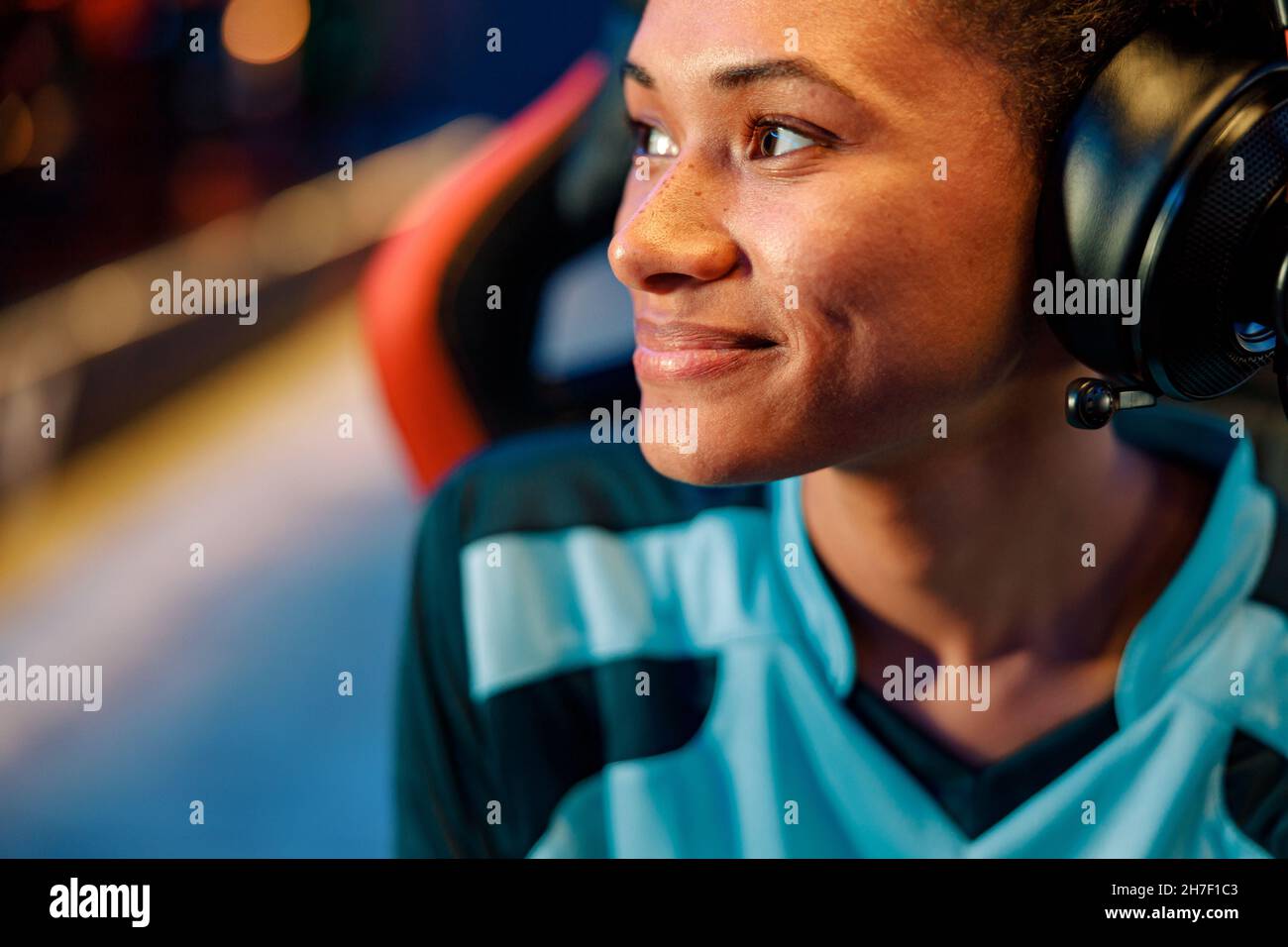 Beautiful female gamer sitting on gaming chair in cyber club Stock ...