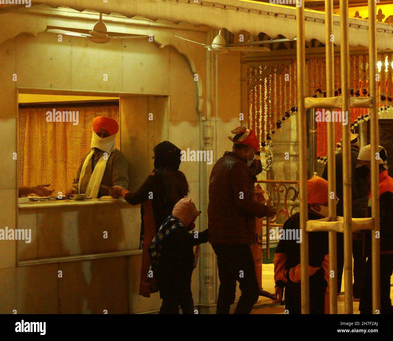 New Delhi, India. 19th Nov, 2021. A Sikh man giving prasad to the ...