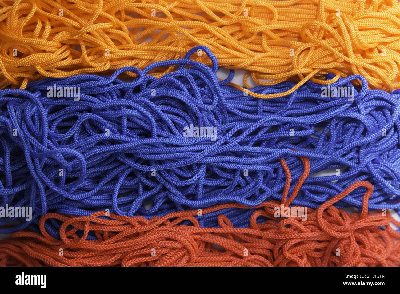 Top view of red, blue and orange thin threads Stock Photo - Alamy