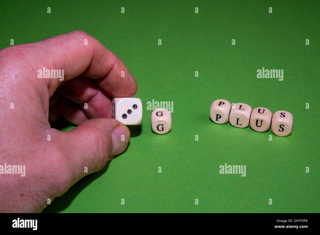 Concept Image 3G plus control, male hand holding dice and a cube with ...