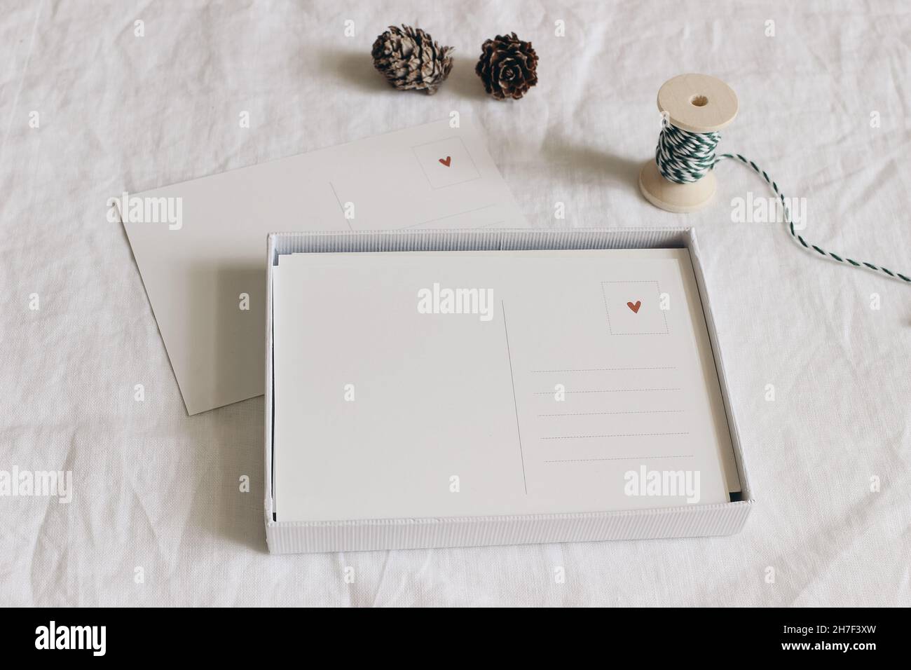 Pile of postcards with red heart in paper box. Blank greeting cards ...