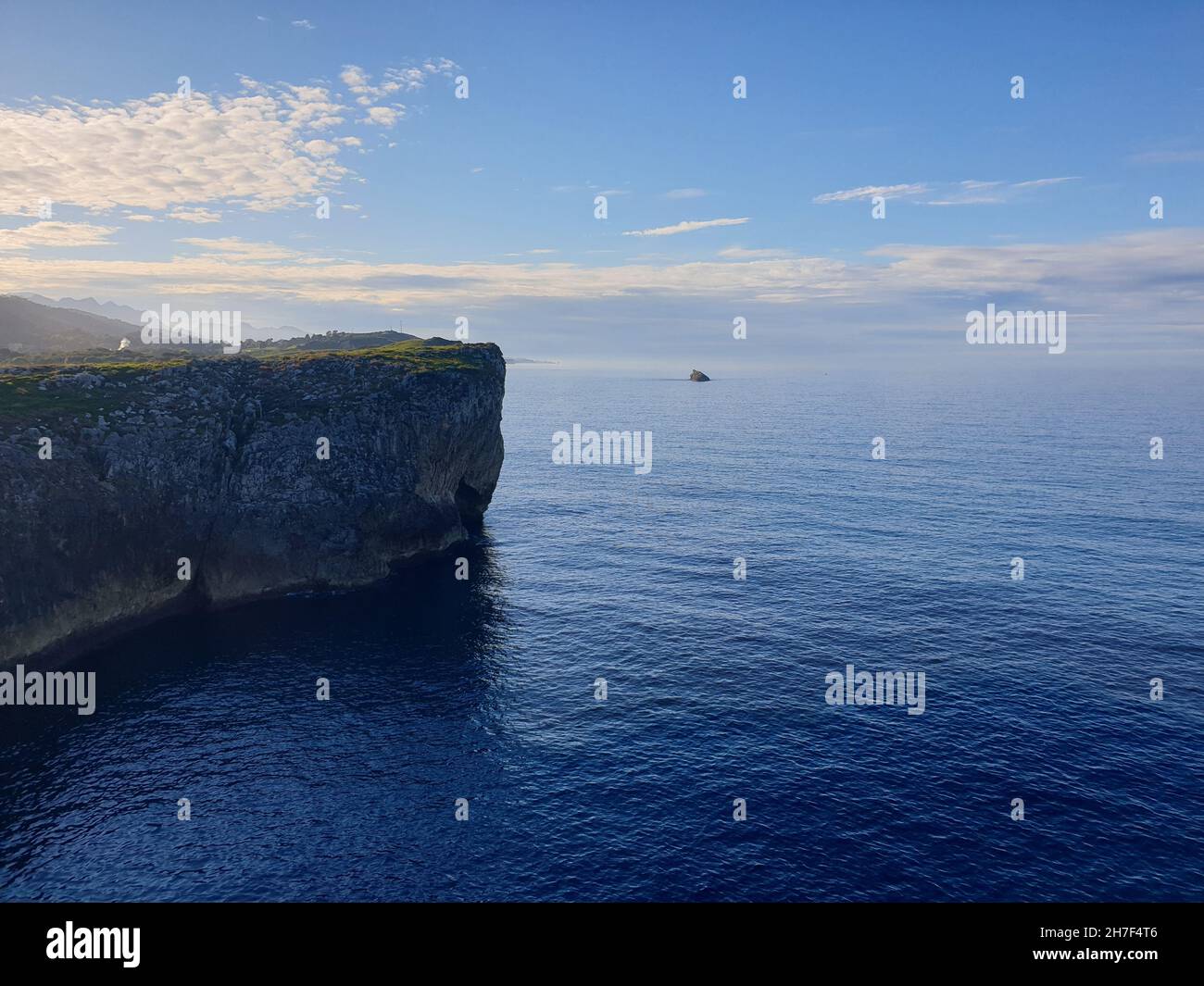 Cliff facing the ocean in the morning Stock Photo - Alamy