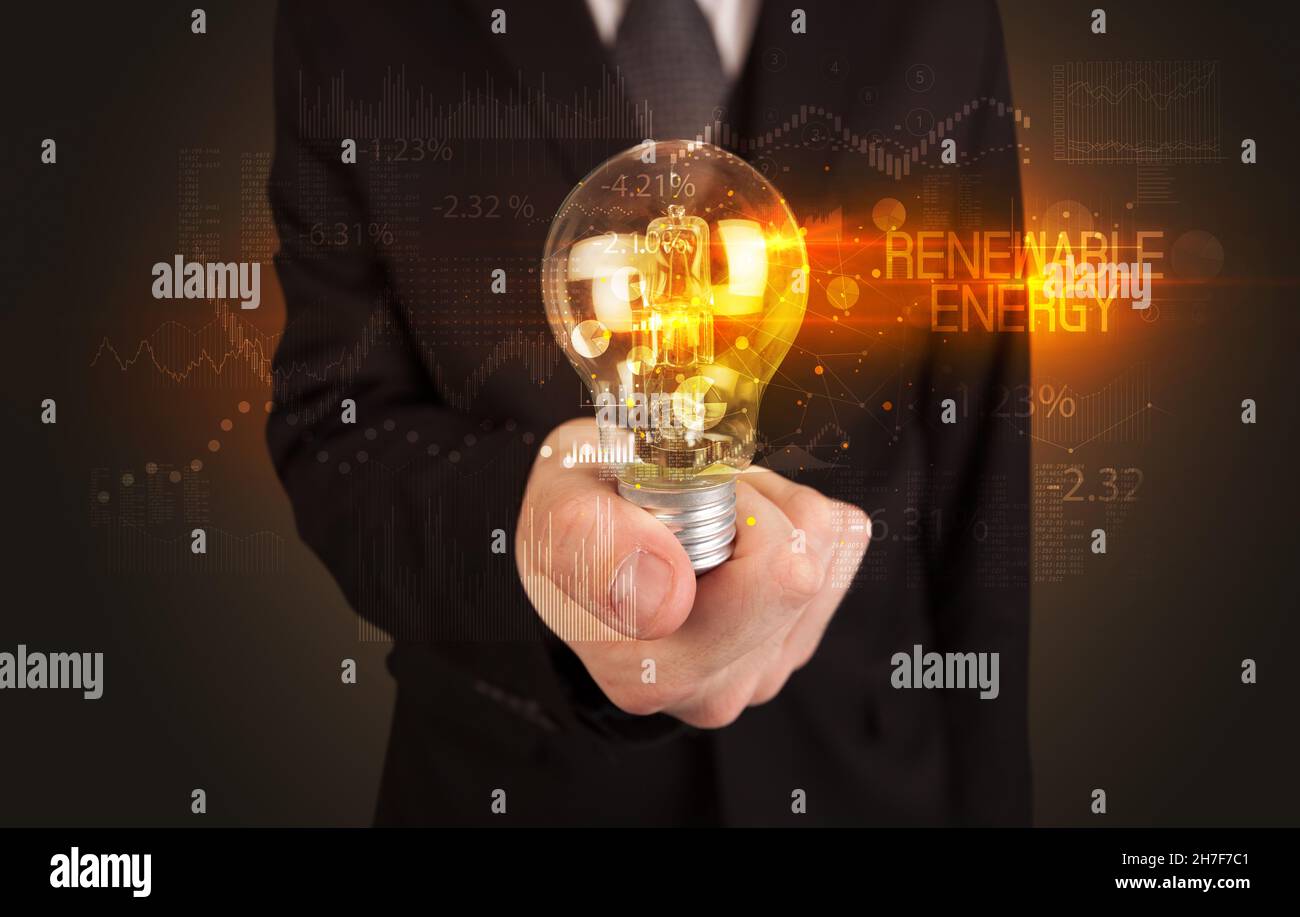 Businessman holding a lightbulb concept Stock Photo - Alamy