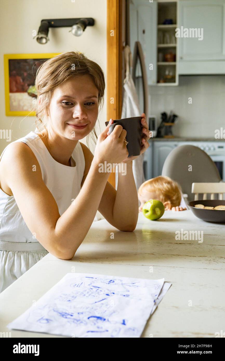Teenager girl drawing picture on paper sheet or making notes use pen ...