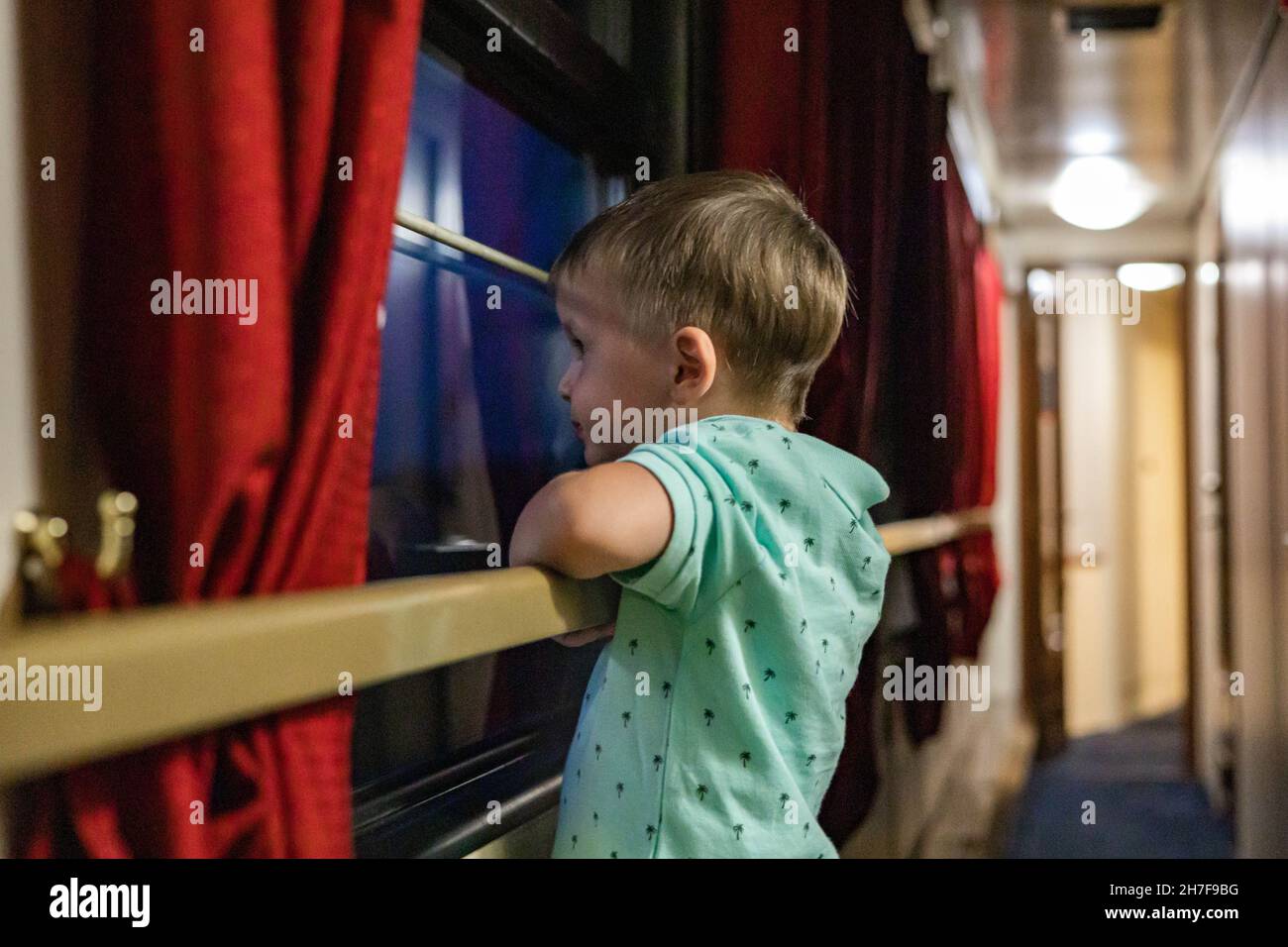 Boy looking through window train hi-res stock photography and images ...