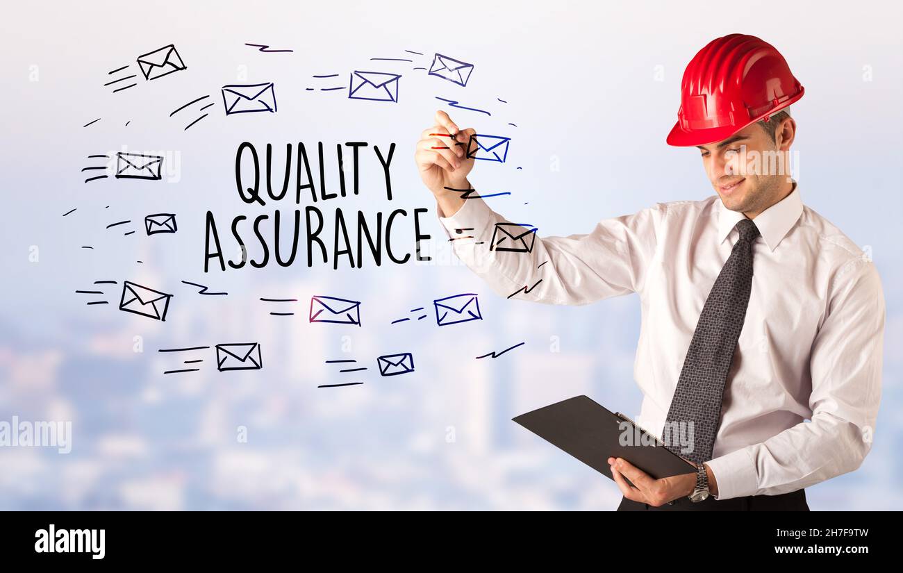 Young businessman with helmet drawing sale sign Stock Photo - Alamy