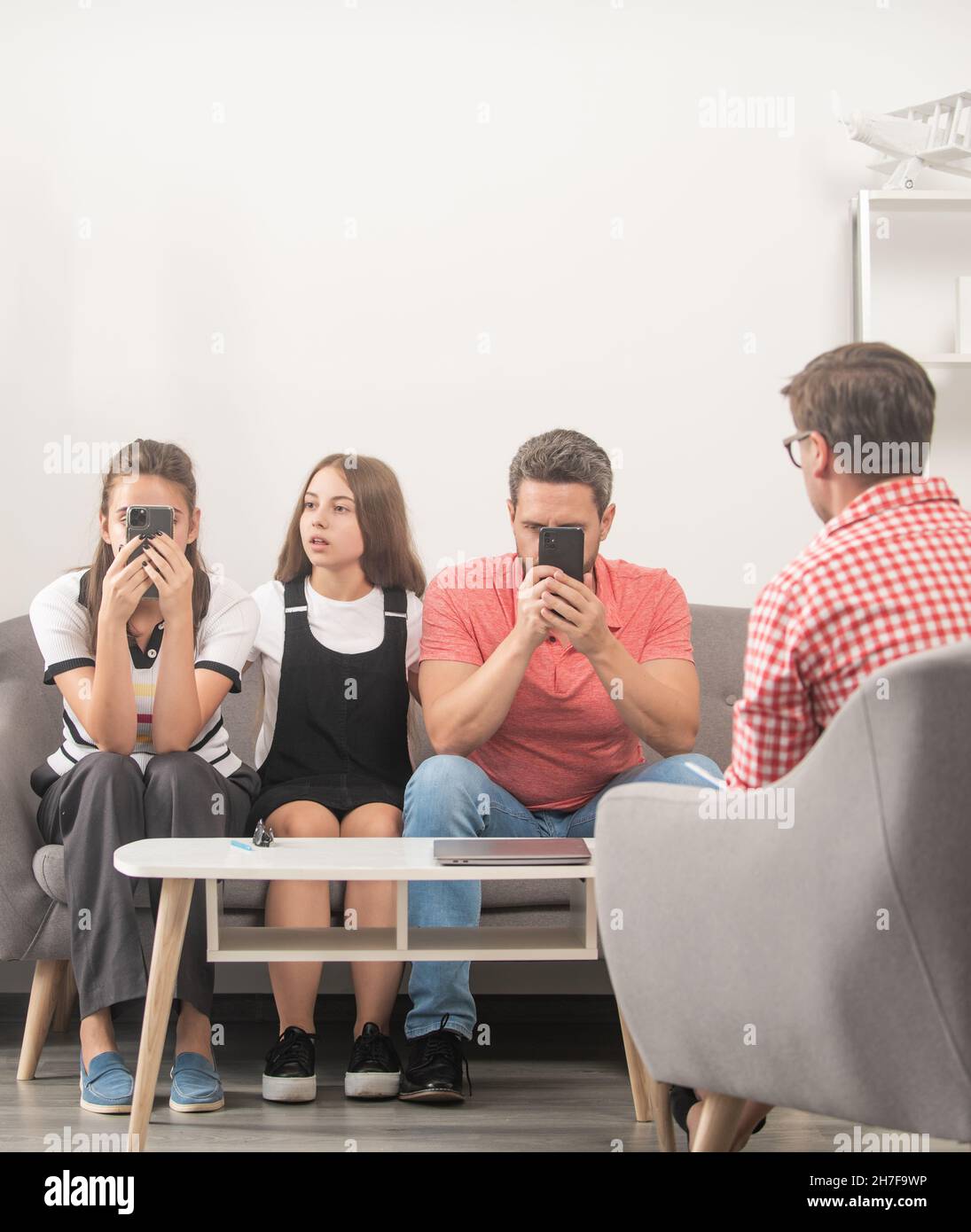 phone addicted father mother and child at family psychologist ...