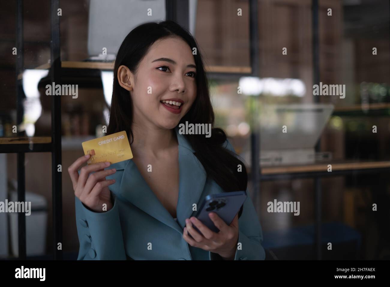 Woman enjoy with online shopping application and typing credit card for ...