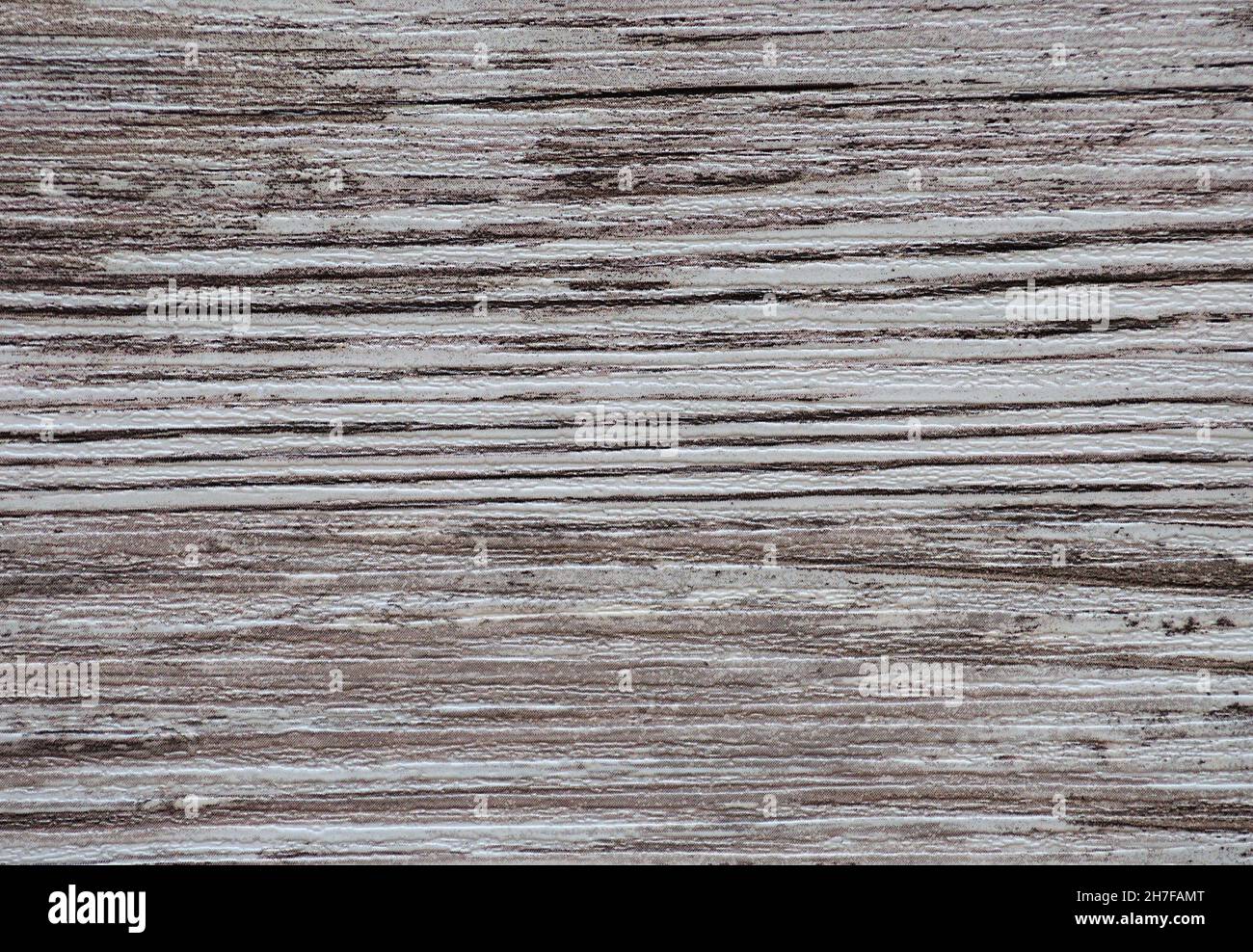 A flat surface of natural dark wood with a striped pattern and signs of ...