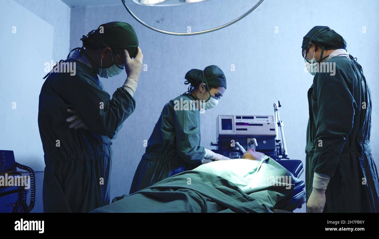 Dead patient surgeon doctor covering face on bed finished operate ...