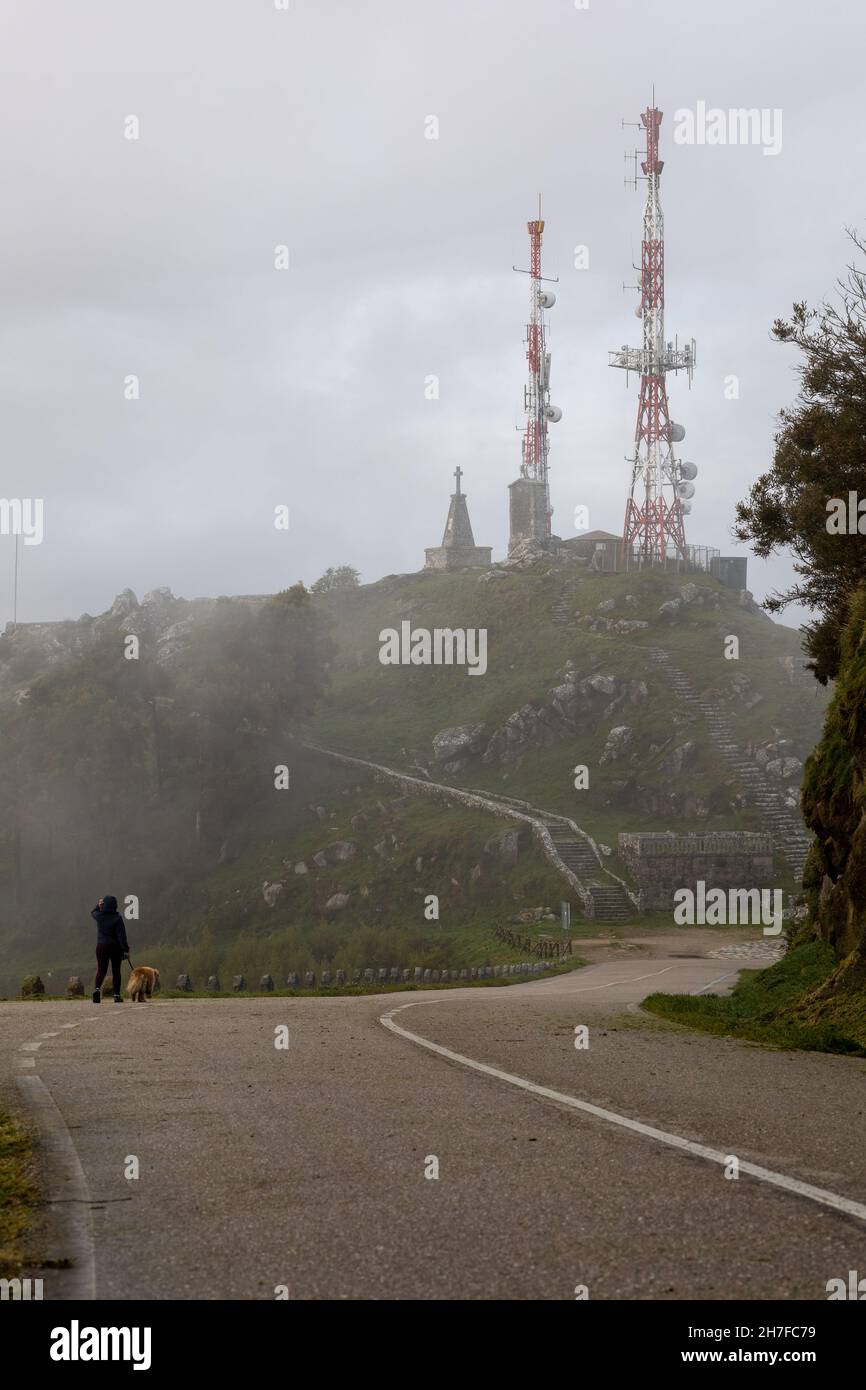 Vertical shot of a road with a background of the telecom transmitter ...