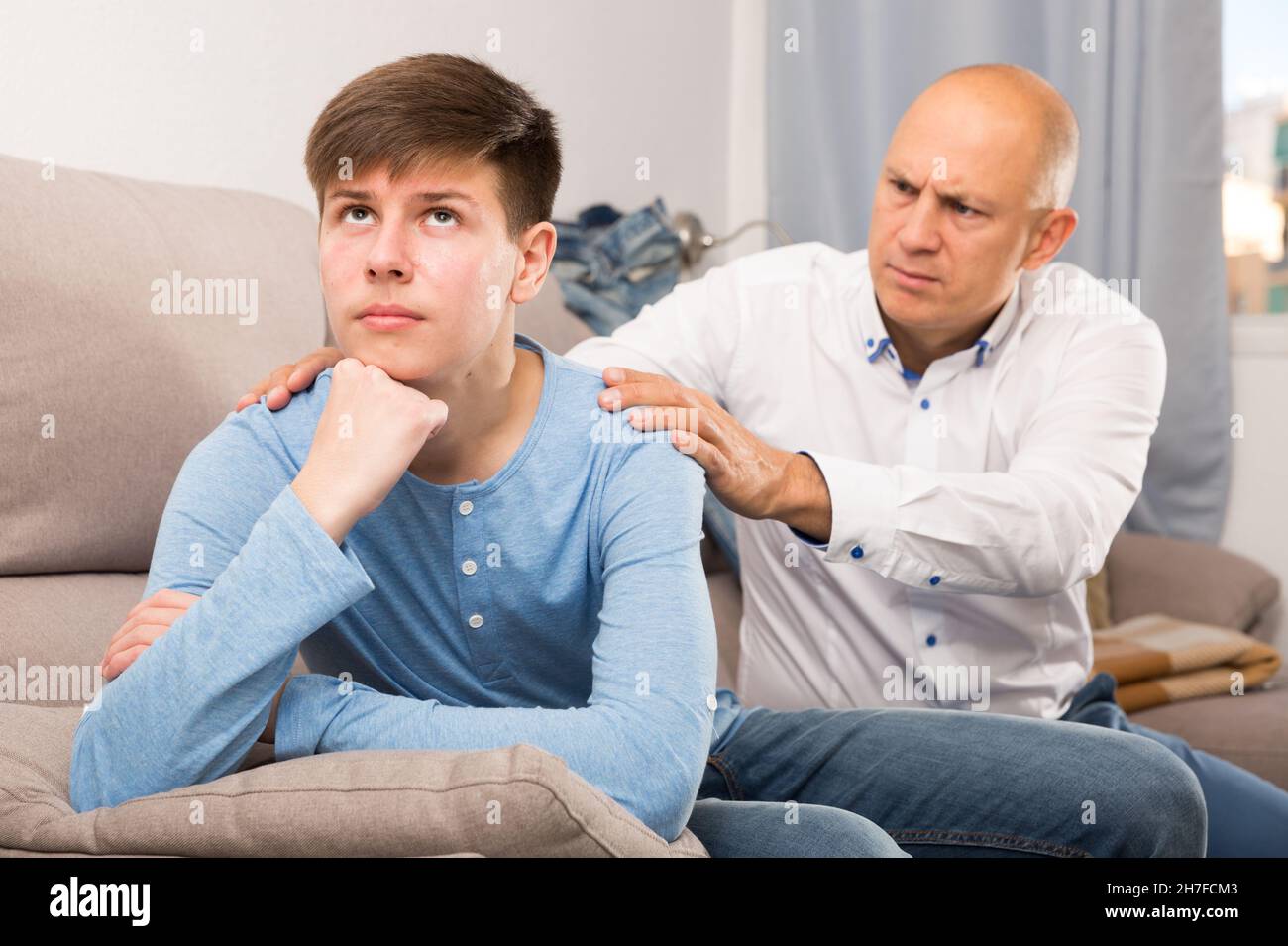 Father calming upset teenage son Stock Photo - Alamy
