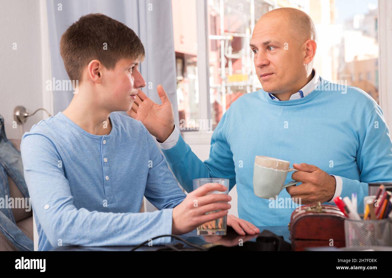Man and his son talking at home Stock Photo - Alamy