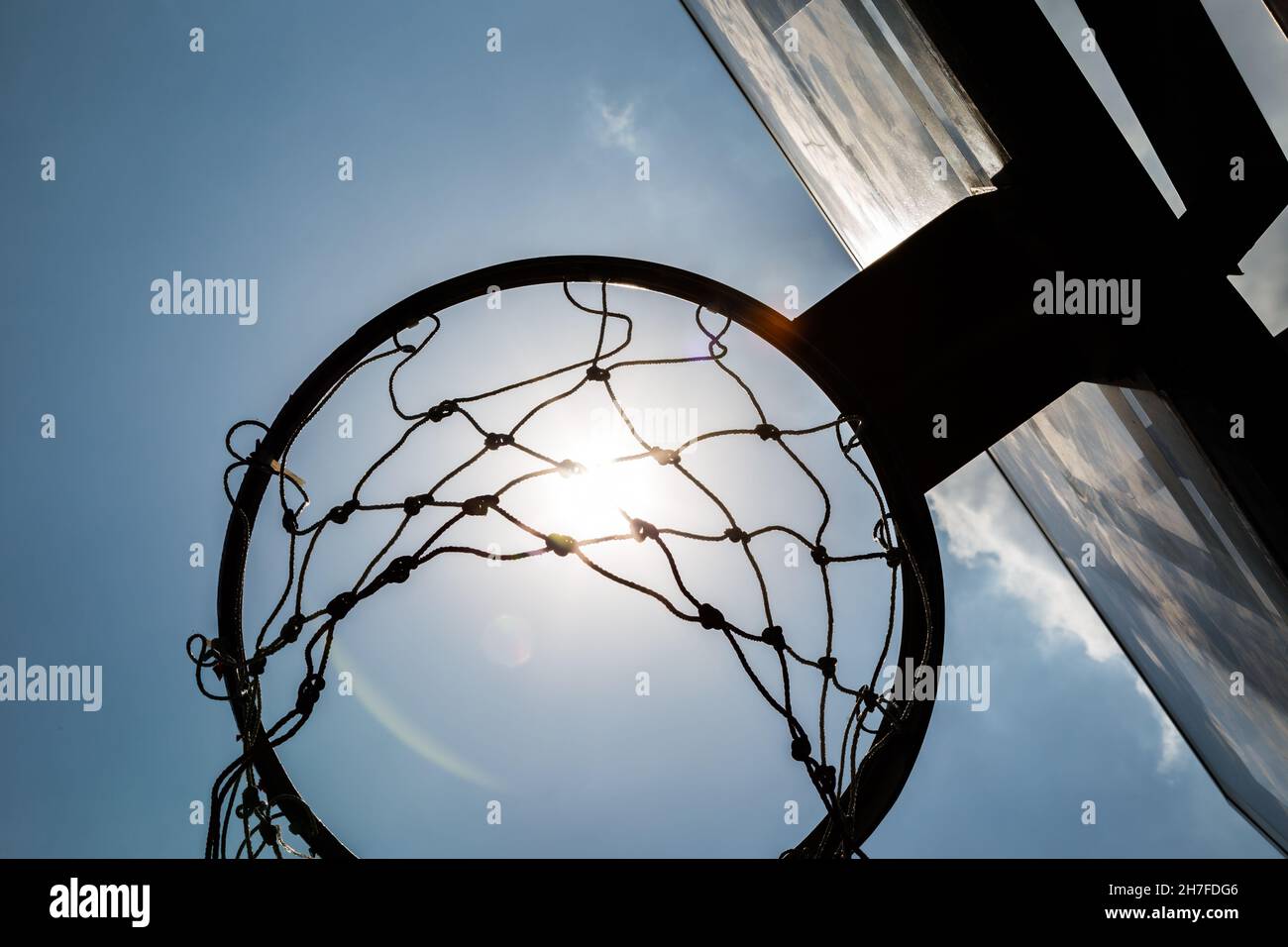 Siluate basketball hoop under the sun and blue sky background Stock ...