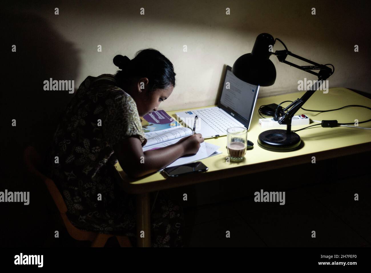 Indonesian school girl doing the home work Stock Photo - Alamy