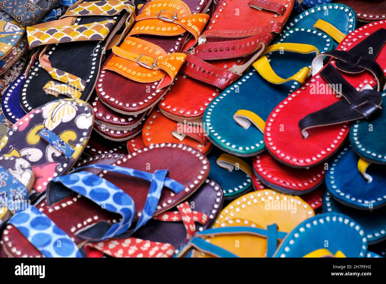 Colorful Handmade chappals (sandals) being sold in an Indian market ...