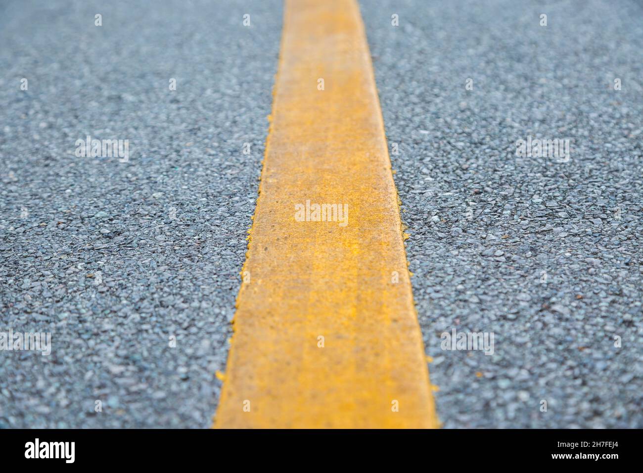 Close up of yellow line on the road background Stock Photo - Alamy