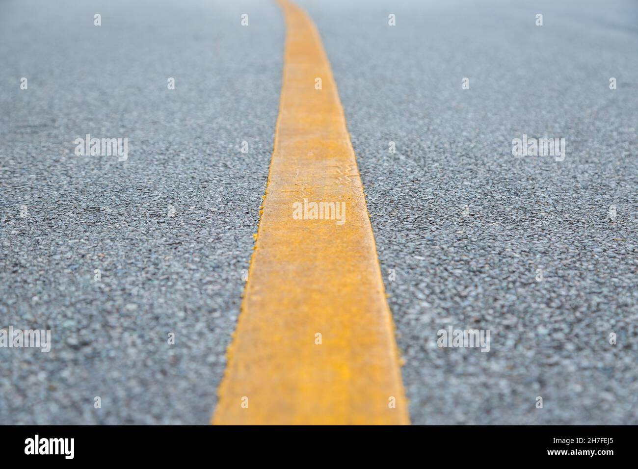 Close up of yellow line on the road background Stock Photo - Alamy